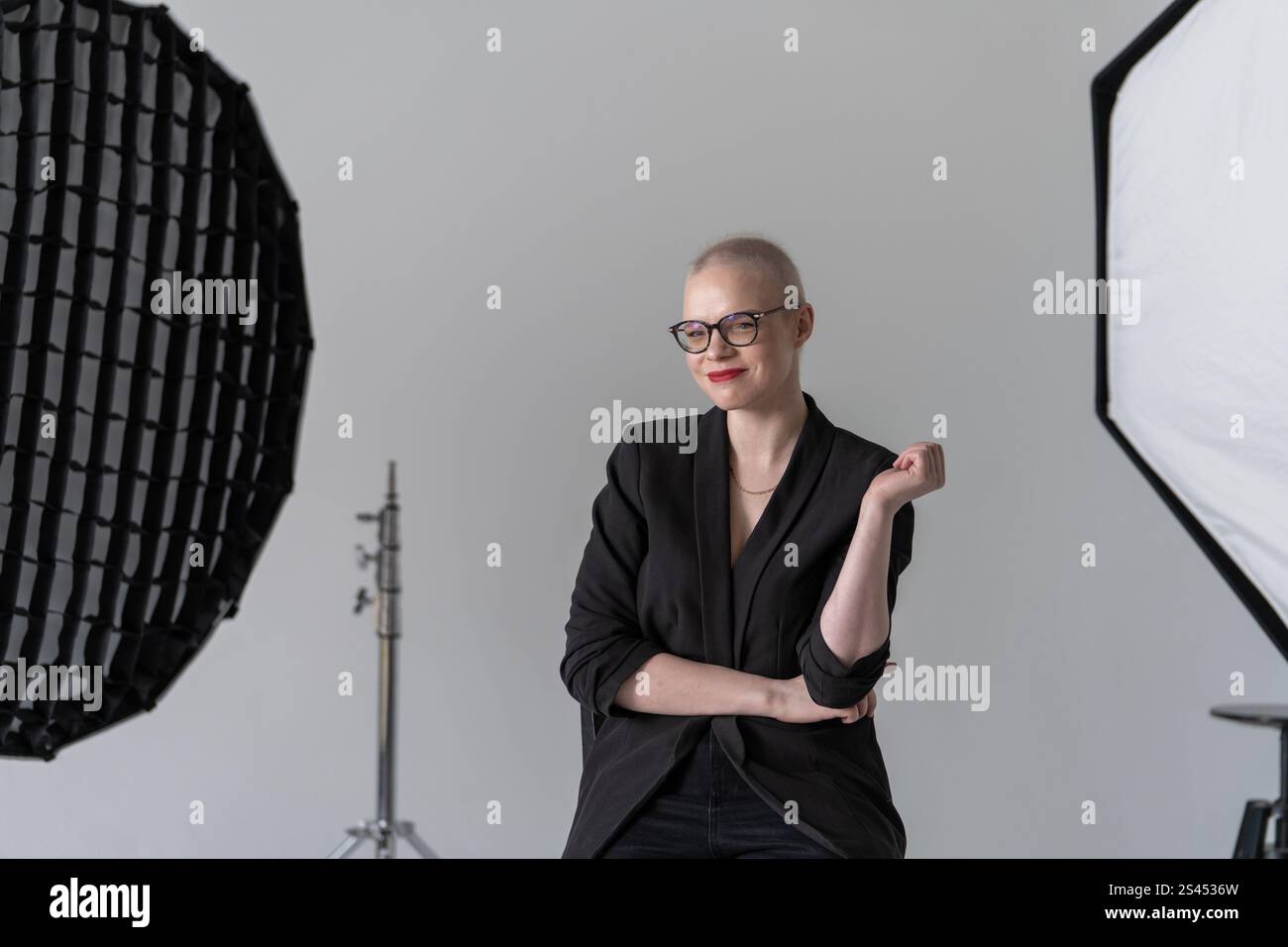 A professional woman poses confidently while seated in a photography ...