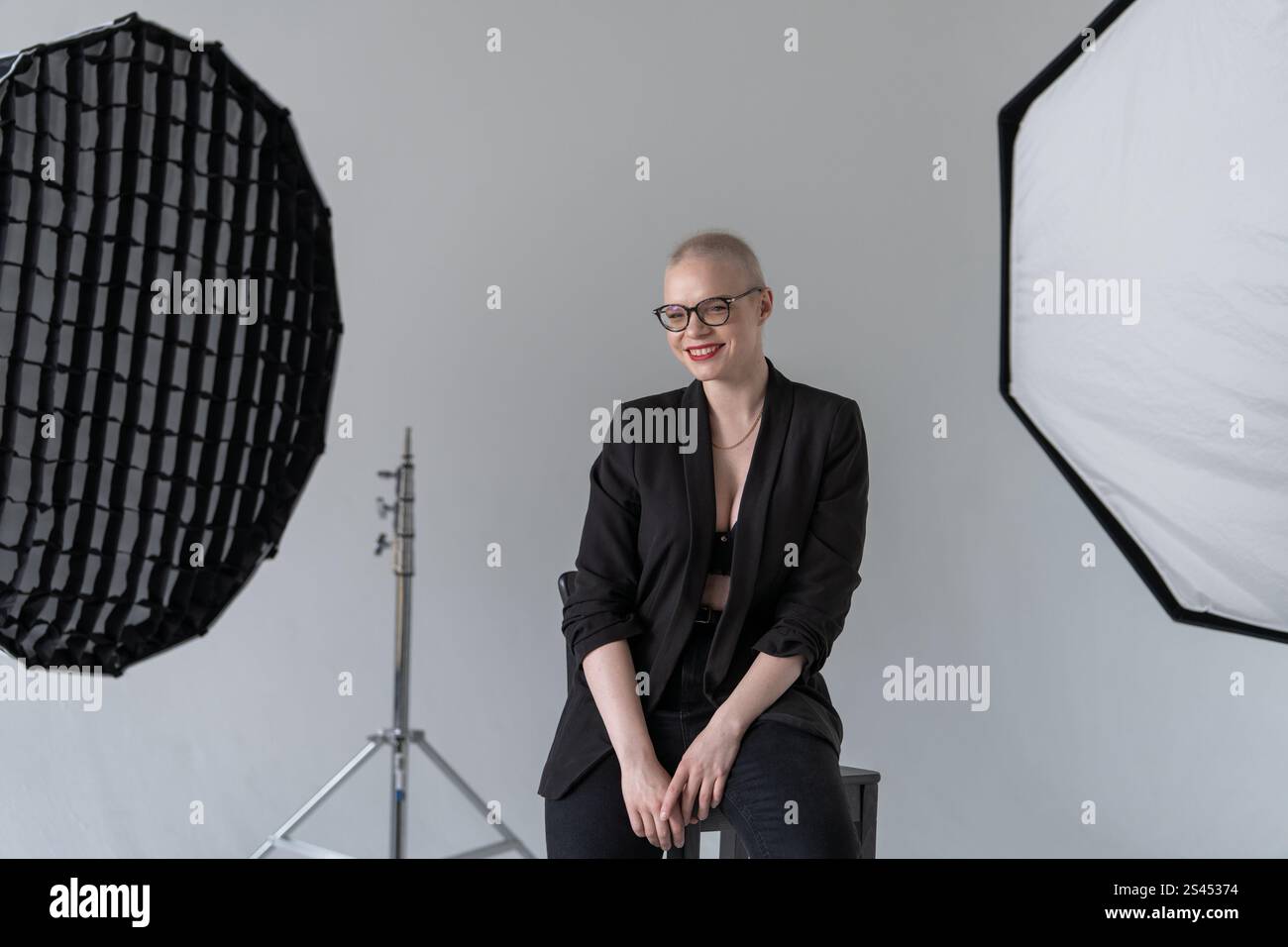 A professional woman poses confidently while seated in a photography ...