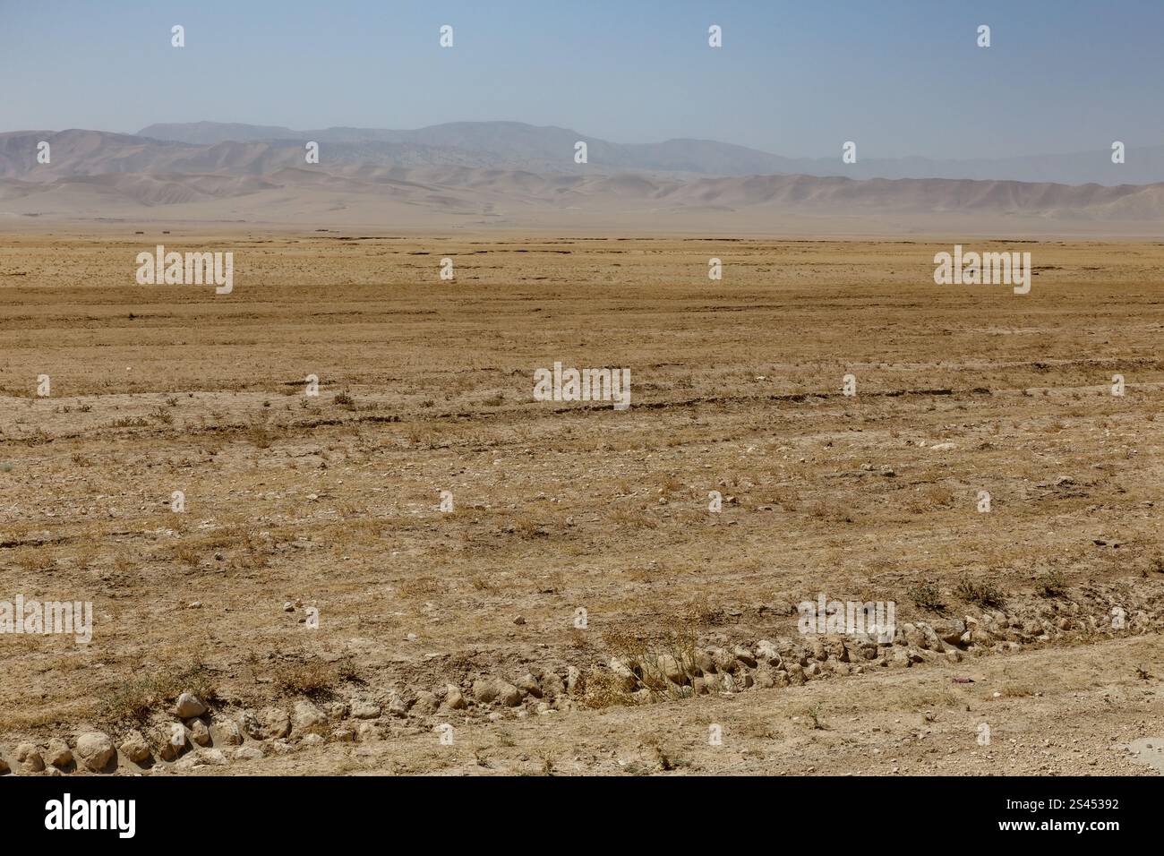 Barren ground stretches across Kunduz Province under a clear sky ...