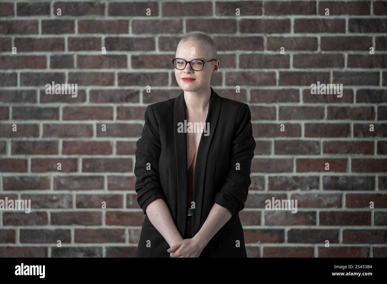 A professional woman poses confidently while seated in a photography ...