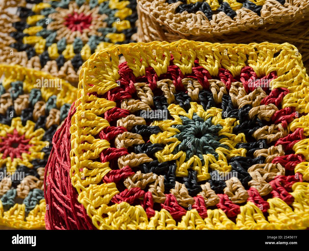 Crocheted raffia patterns. Granny square made of multi-colored raffia ...