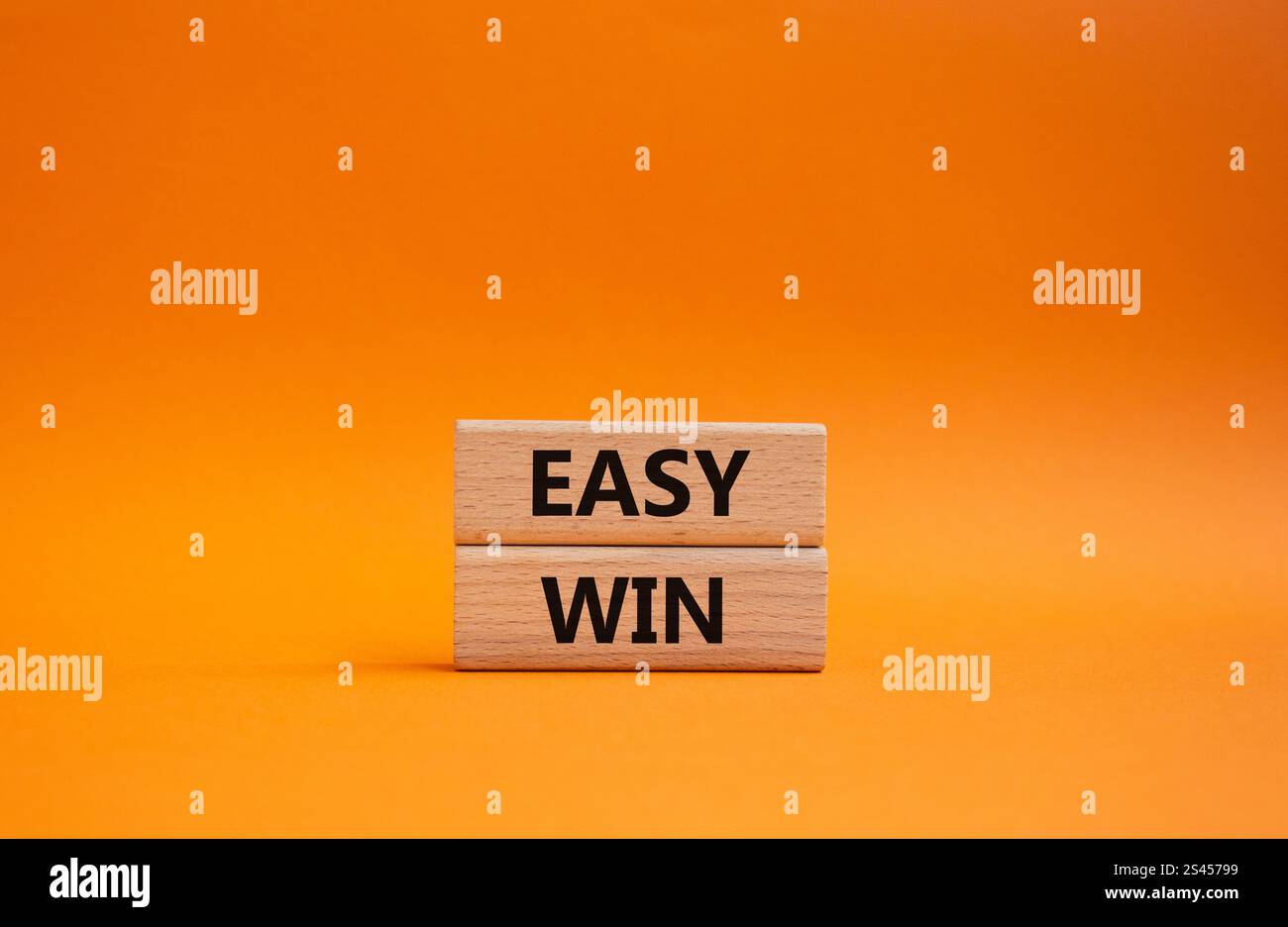 Easy win symbol. Wooden blocks with words 'Easy win'. Beautiful orange ...