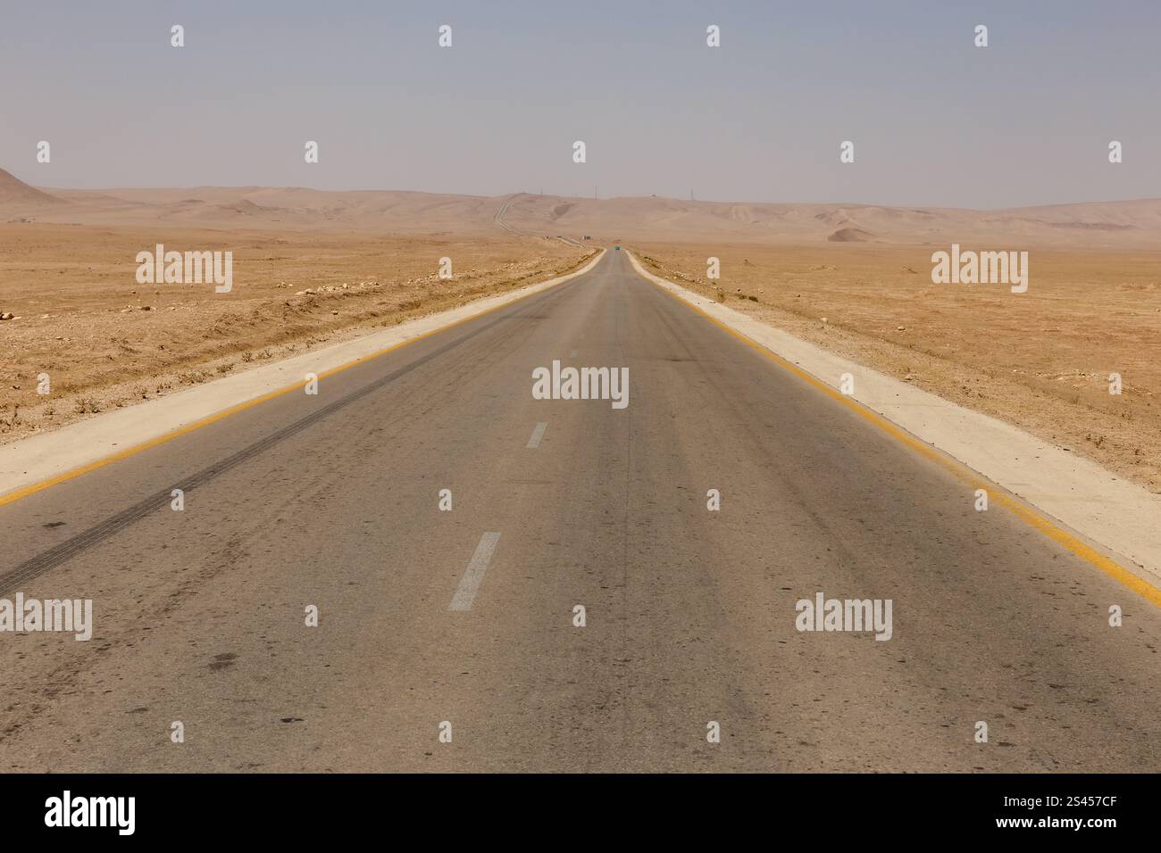 A long, straight highway cuts through the barren terrain of Kunduz ...