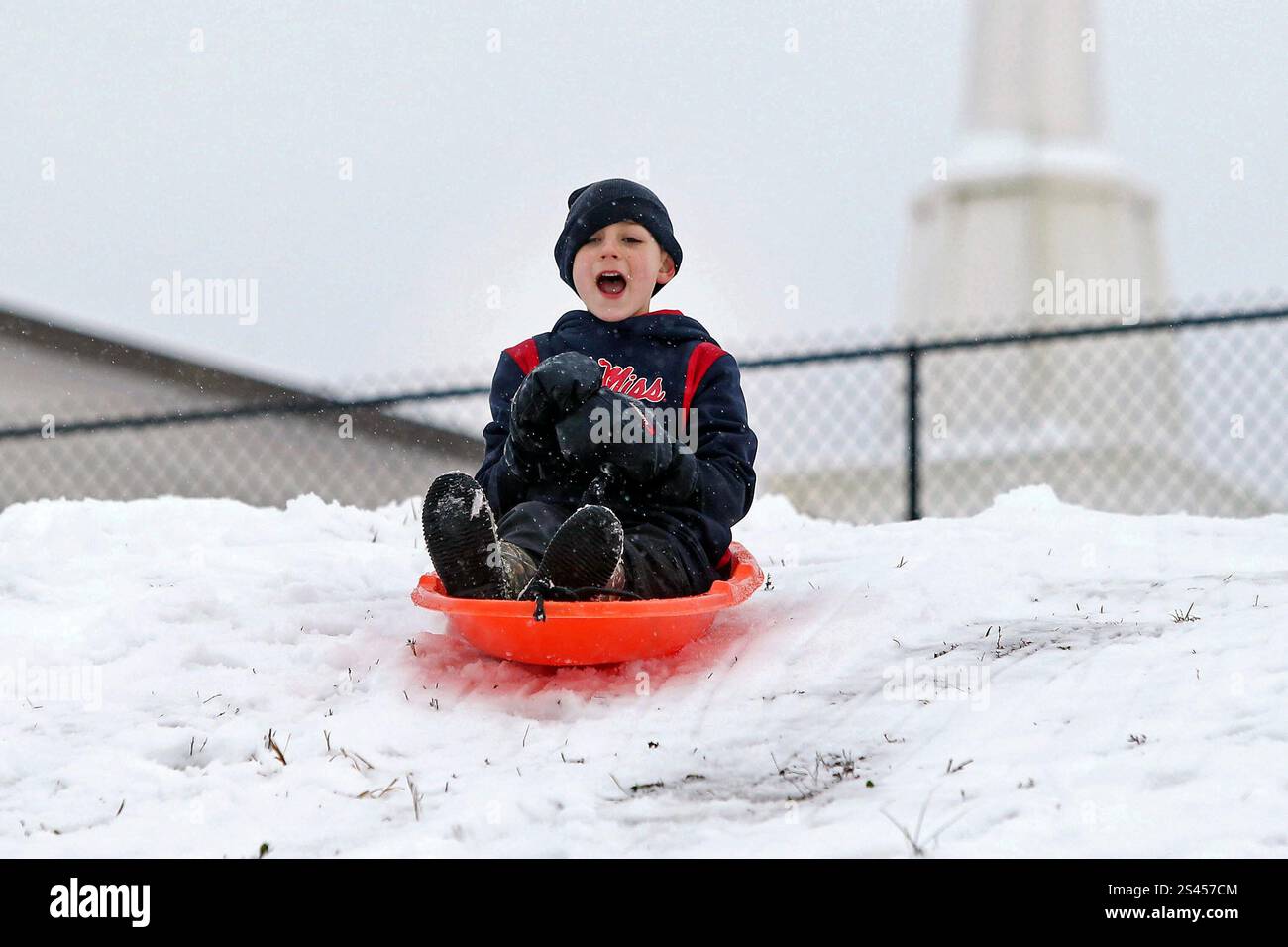 Nathan Bremseth, 8 of Tupelo, shouts out in excitement as he sleds down ...