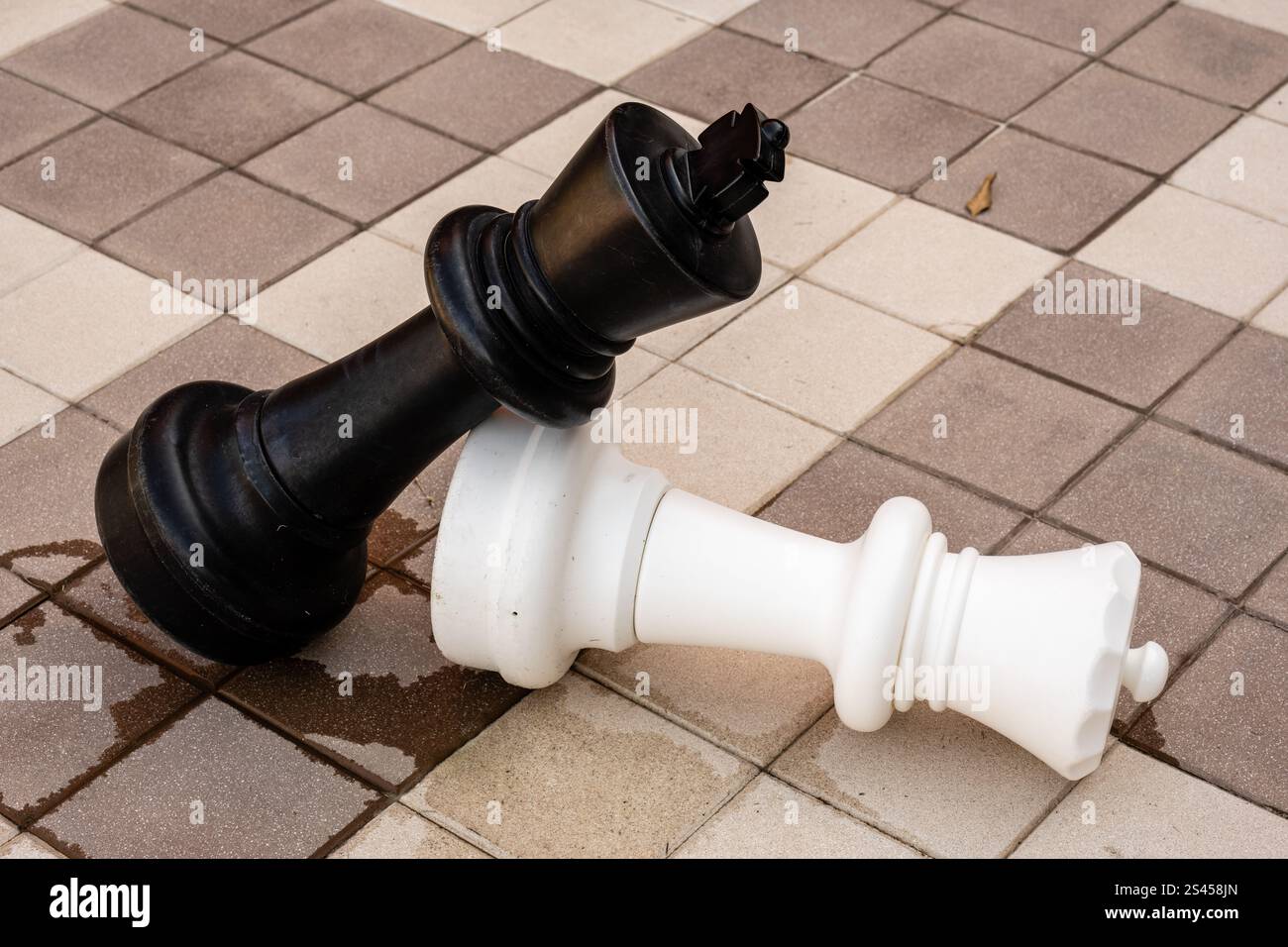 giant outdoor chess pieces, a toppled white king by black king Stock ...