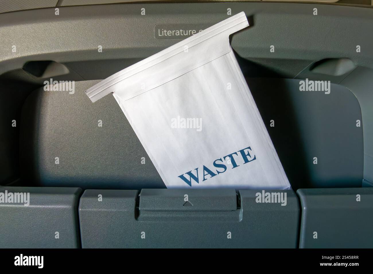 motion sickness bag in an airplane seat back labelled Waste Stock Photo ...