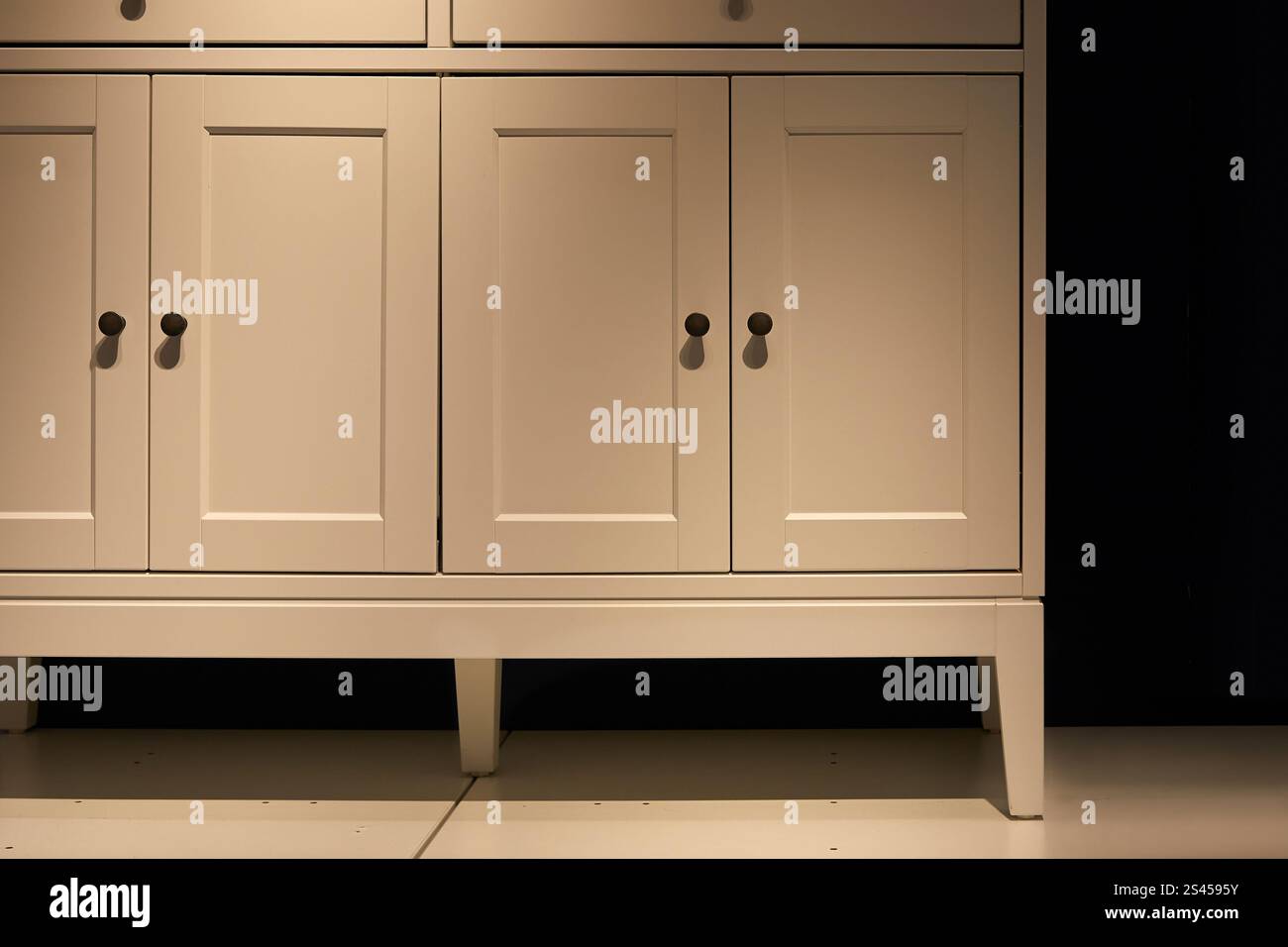 White kitchen cabinets in dim light Stock Photo - Alamy