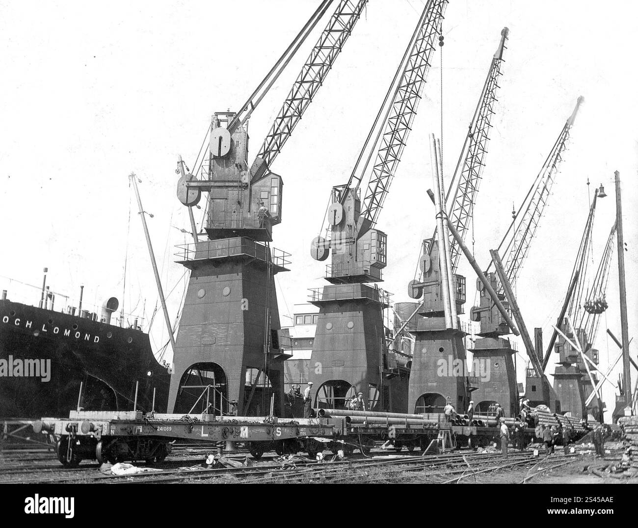 Pipes being loaded onto a cargo ship at Barry Docks, circa 1936-40 ...