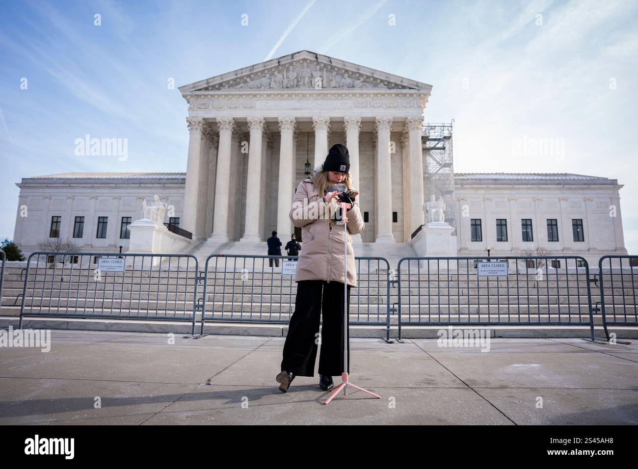 Sarah Baus uses her phone after speaking on a TikTok Live outside the ...