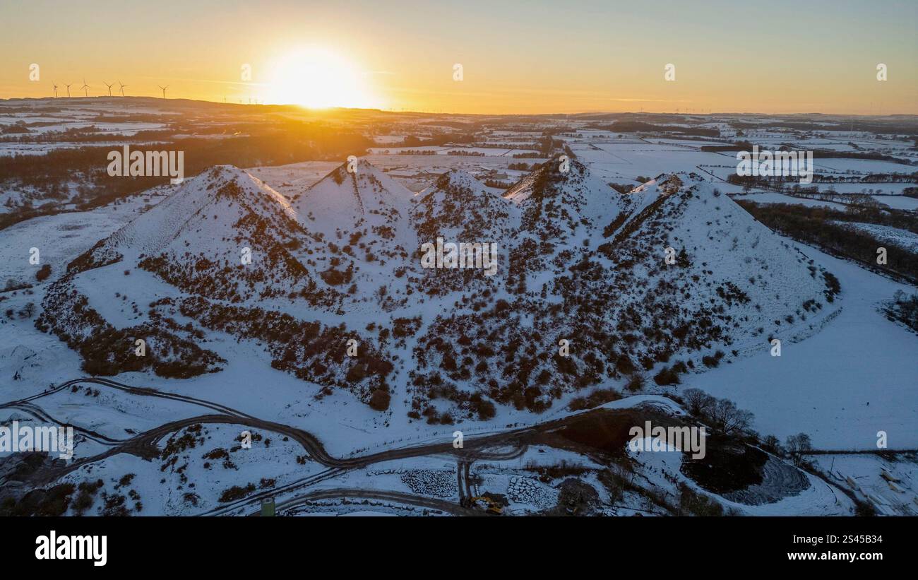 Aerial view of the Five Sisters shale bing after snowfall, West Calder ...