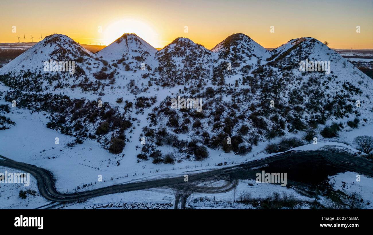 Aerial view of the Five Sisters shale bing after snowfall, West Calder ...