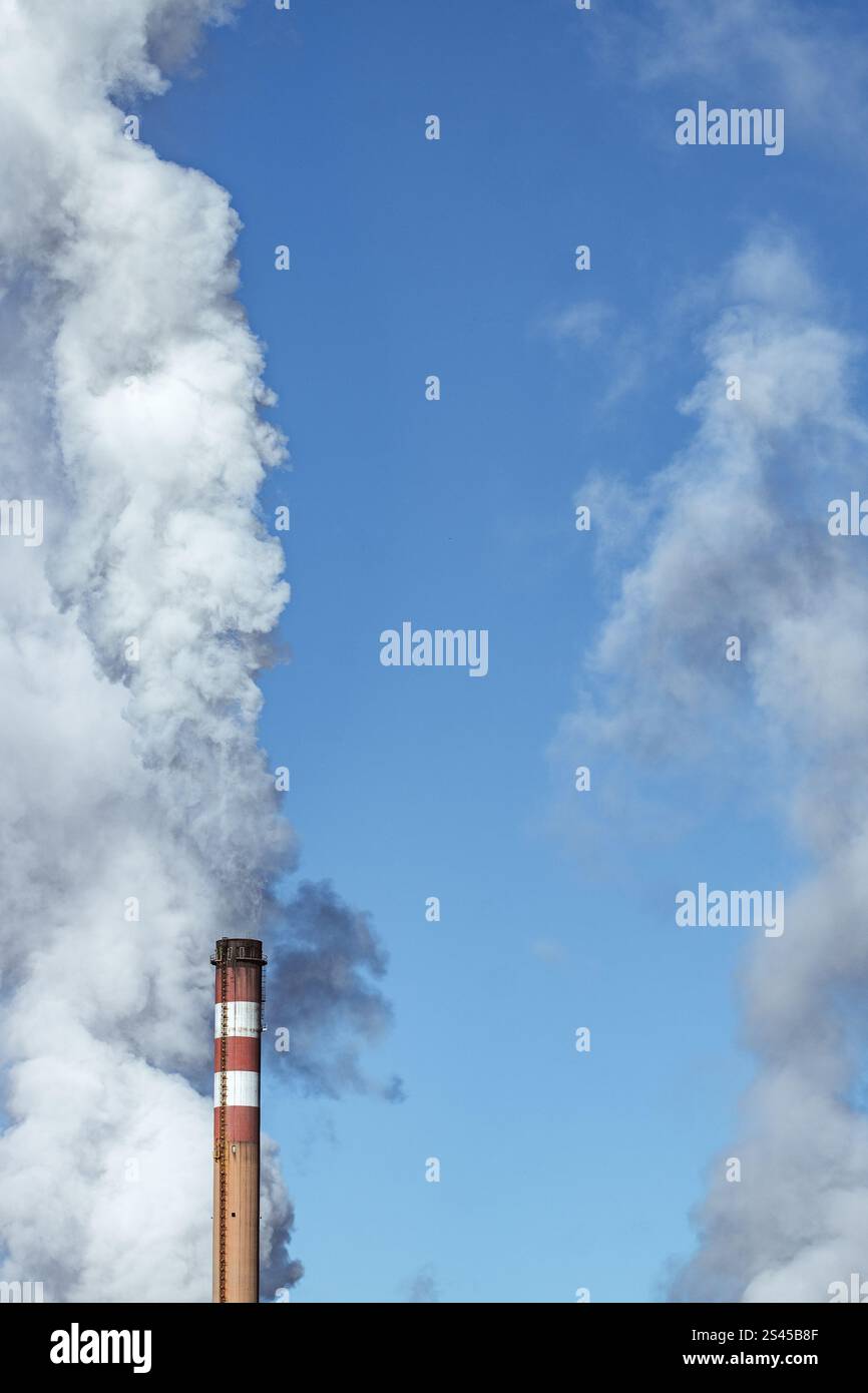 Cooling towers and Chimneys of a coat-fired power plant fuming white ...