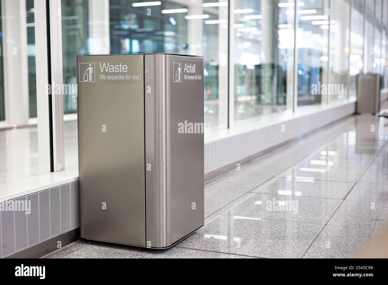 Large, square, metal garbage bin or can inside international airport ...