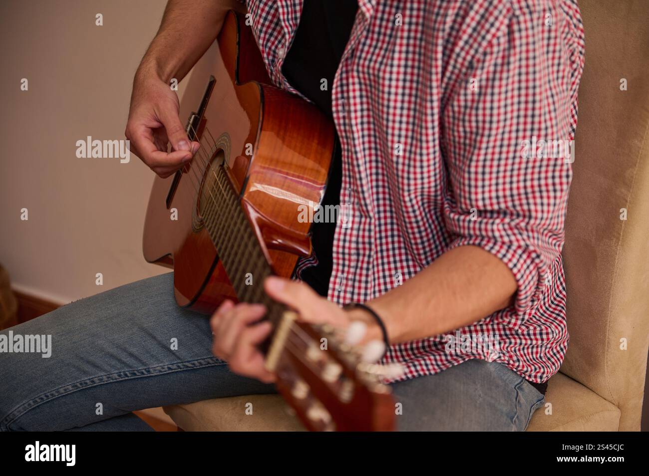 A close-up photograph showing the hands of a person playing a classical ...