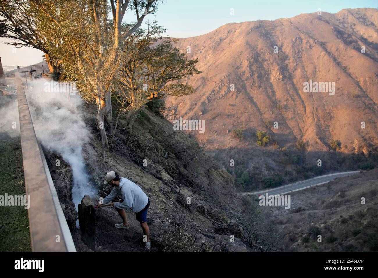Garrett Yost gathers puts out hotspots from his neighbors' fire-ravaged ...