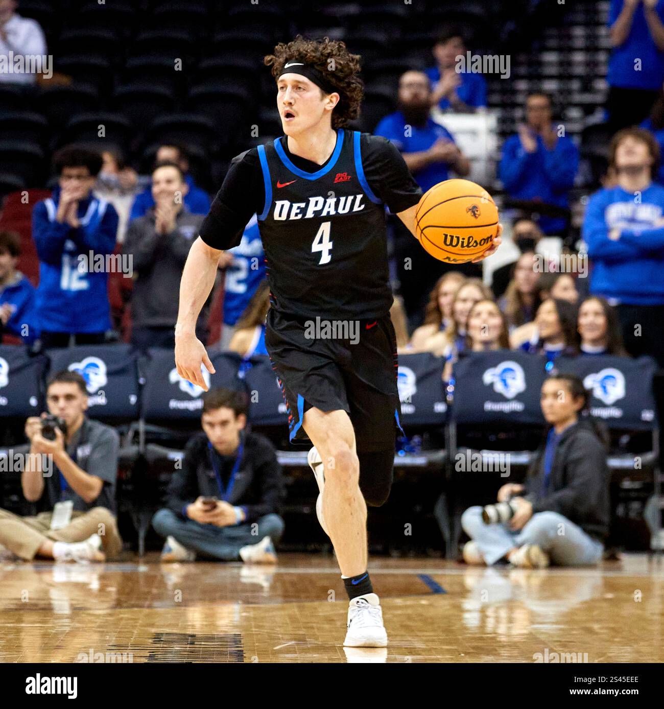 DePaul Blue Demons guard Conor Enright (4) brings the ball up court ...
