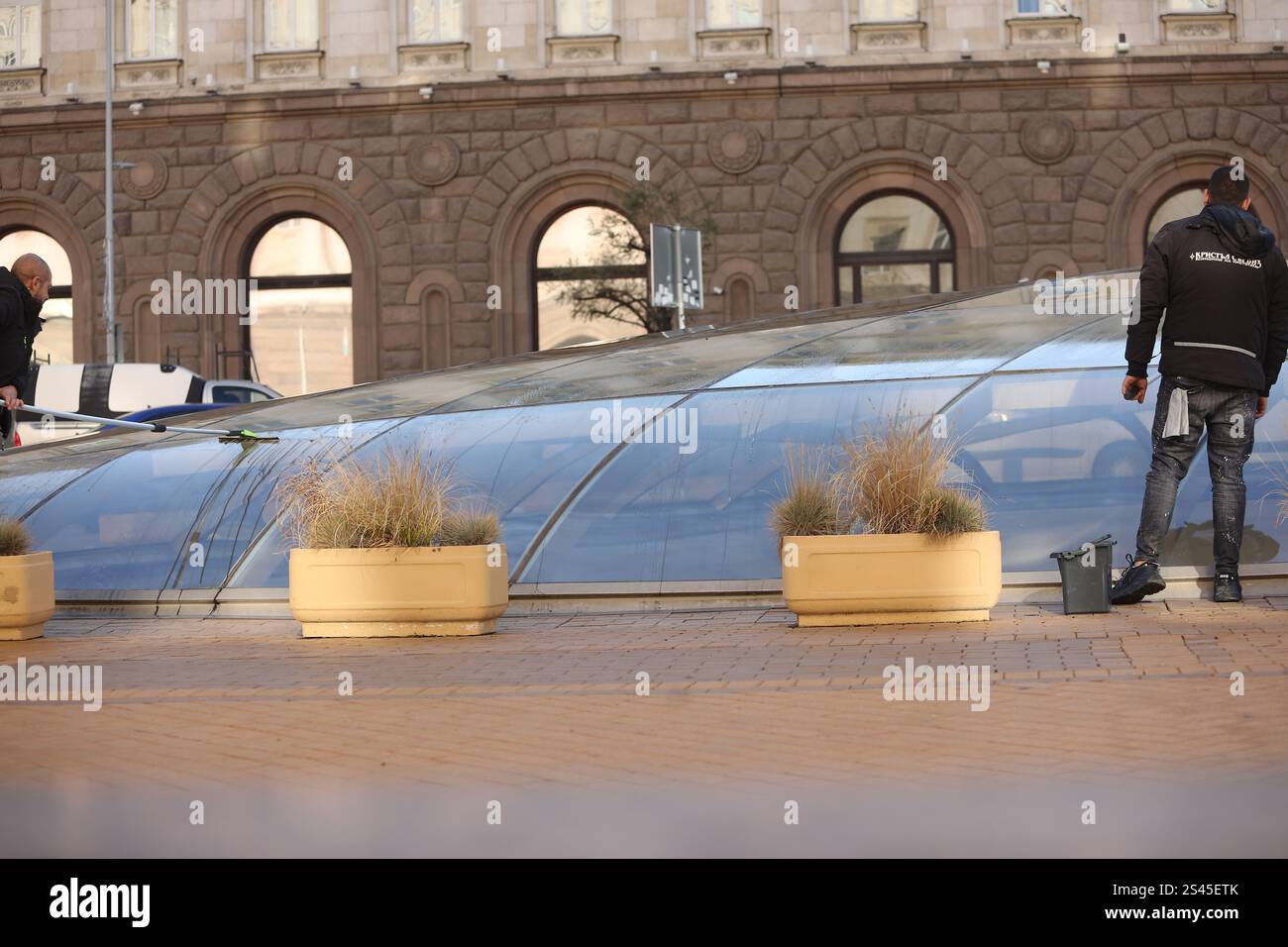Workers wash and clean the glass dome of the ancient cultural and ...