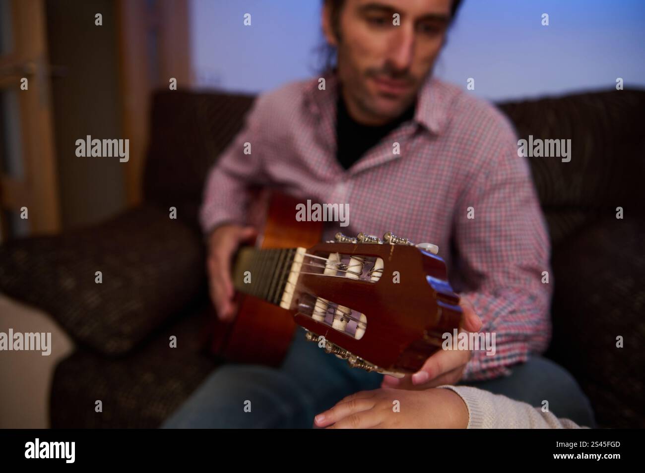 Detailed view hands plucking strings hi-res stock photography and ...