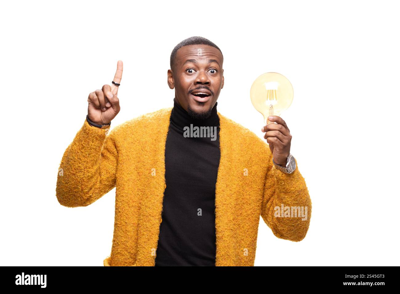A man celebrates a bright idea, holding a light bulb and raising his ...