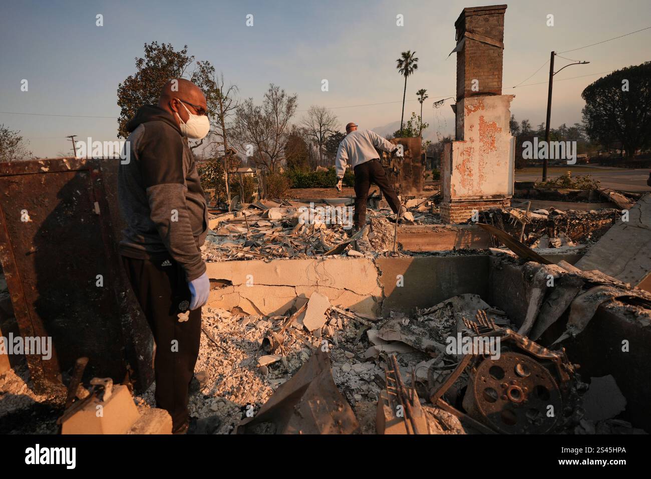 Kenneth Snowden, left, surveys the damage to his fire-ravaged property ...