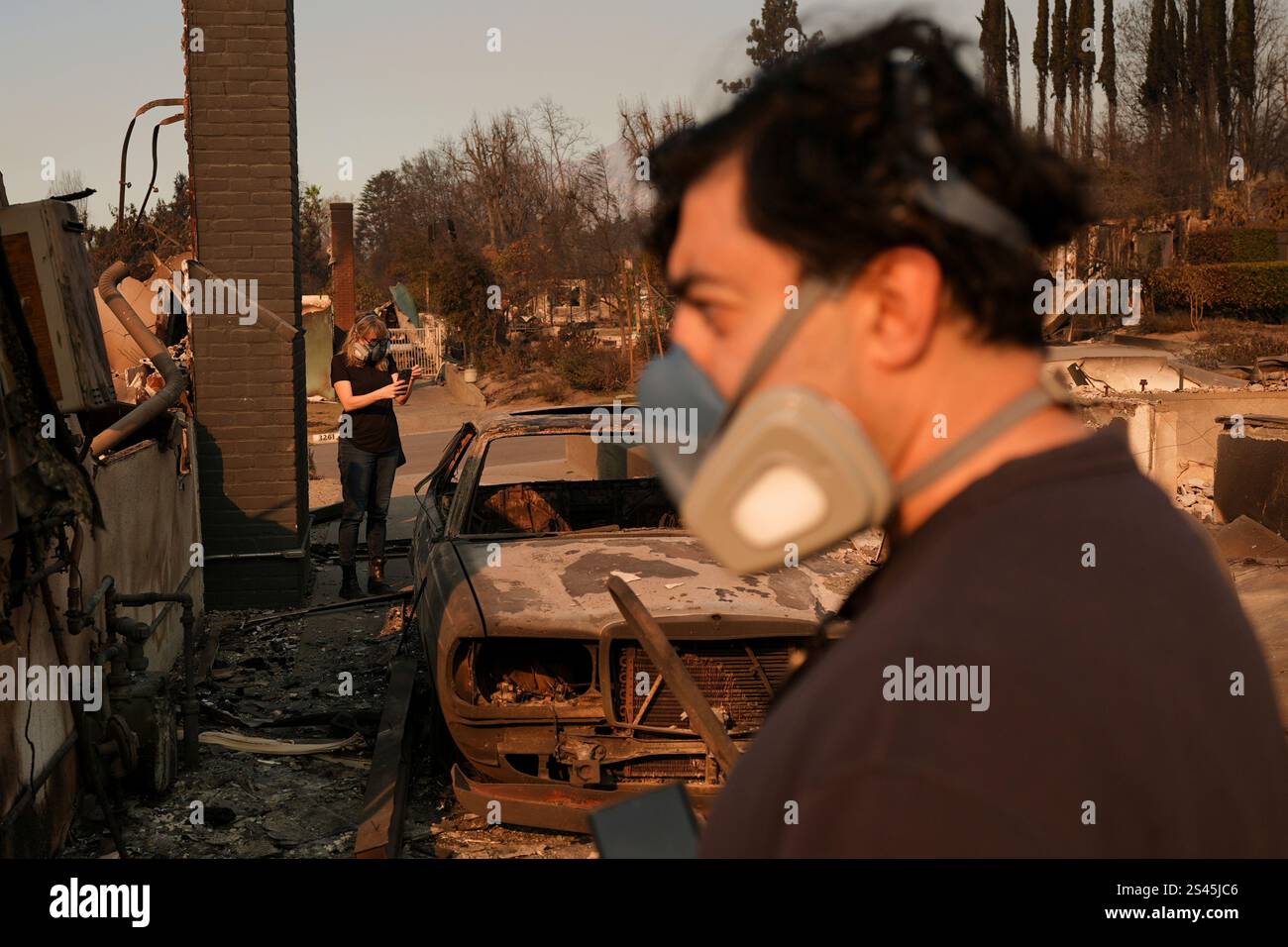 Homeowners Sohrab Nafici, right, and Christine Meinders return to their ...