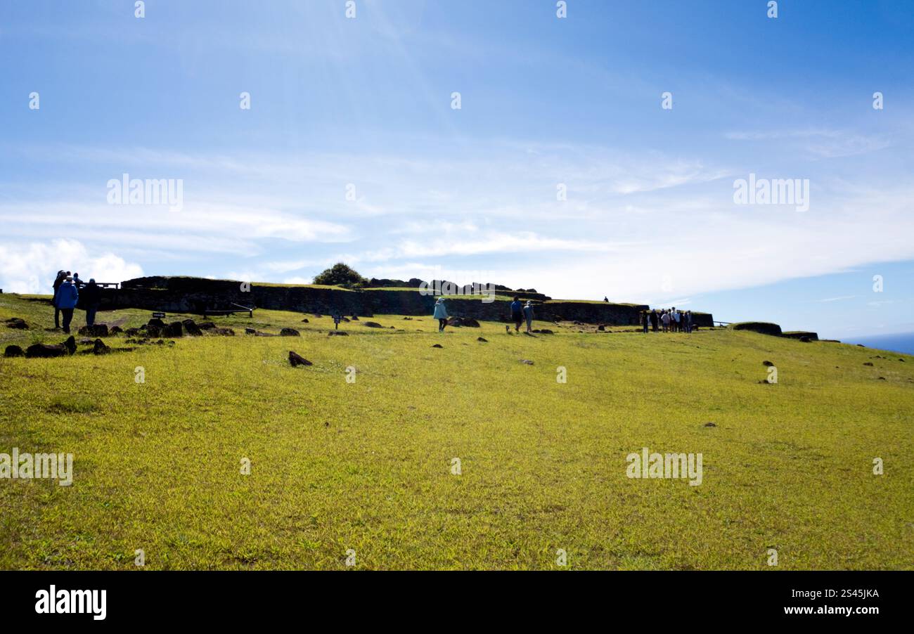 Tour group visits Orongo, sod-covered, windowless, buildings that were ...