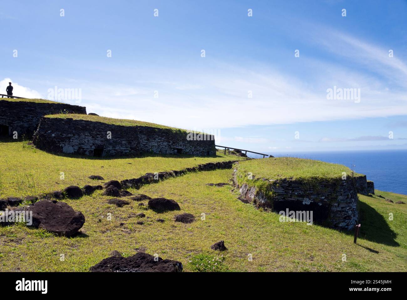 A tourist views Orongo, sod-covered, windowless, buildings that were an ...
