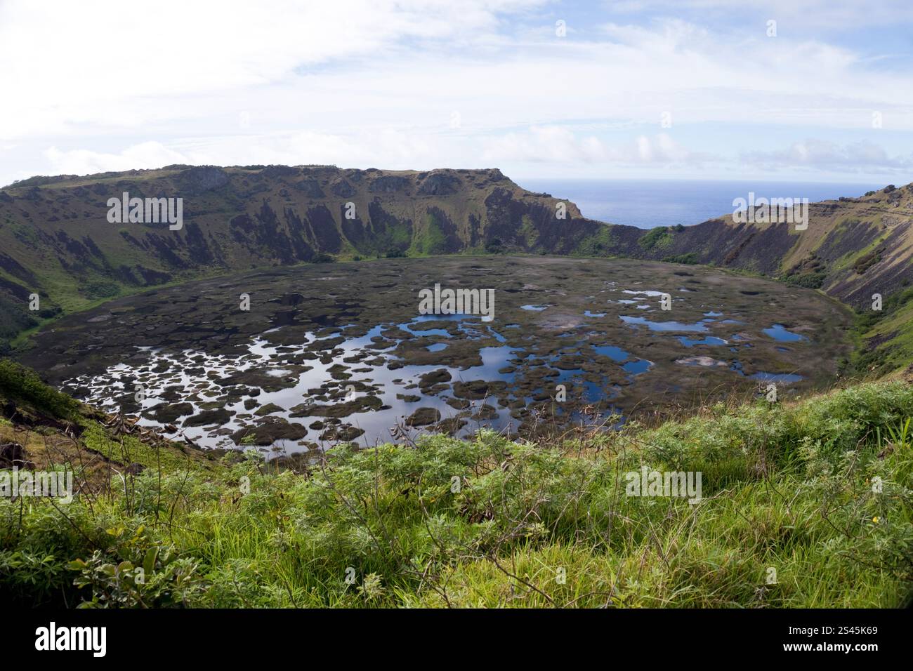 Water sits in the bottom of the crater at Rano Kau, the extinct volcano ...