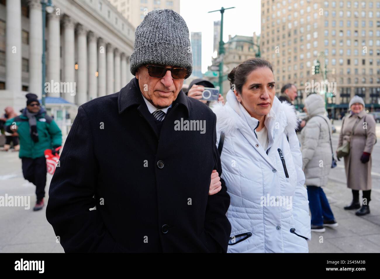 Erden Arkan, left, leaves federal court, Friday, Jan. 10, 2025, in New ...