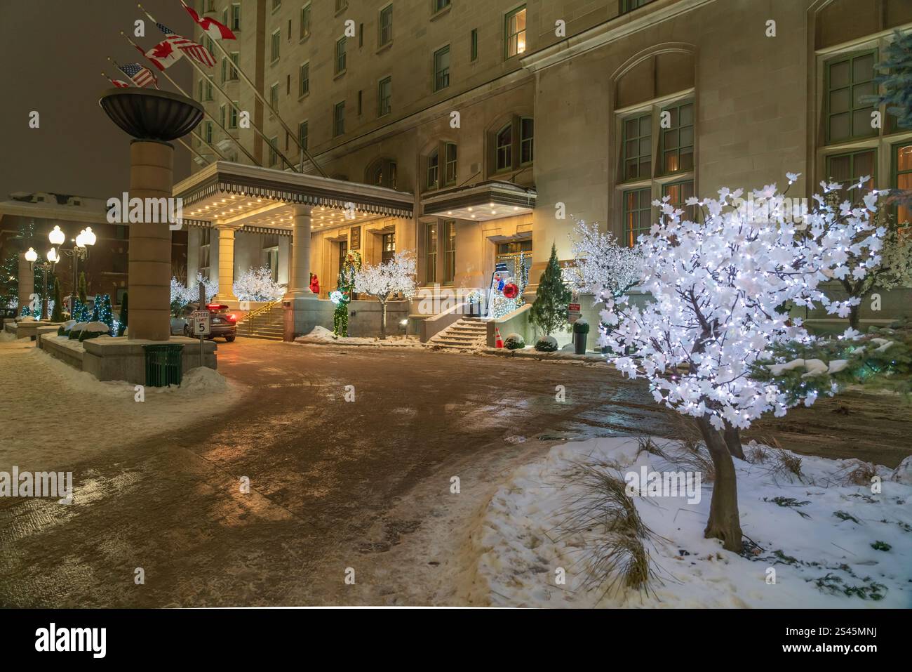 The entrance of The Fort Garry hotel illuminated at night in winter ...