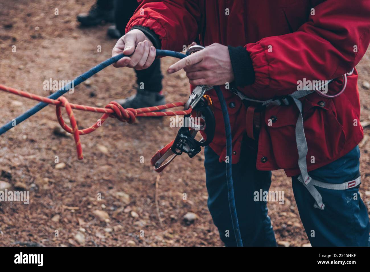 Rock climber tying knot on rope for climber man preparing climbing ...