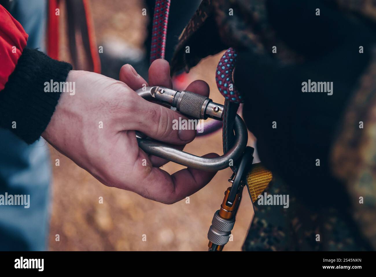 Rock climber tying knot on rope for climber man preparing climbing ...