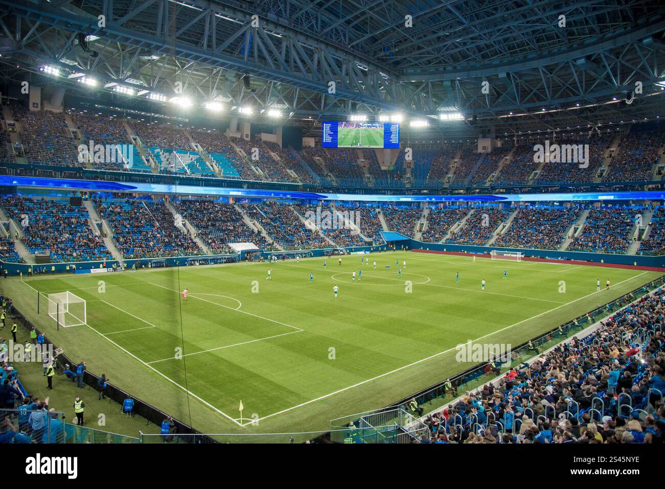 Football match on the soccer field, fans are sitting in the stands ...