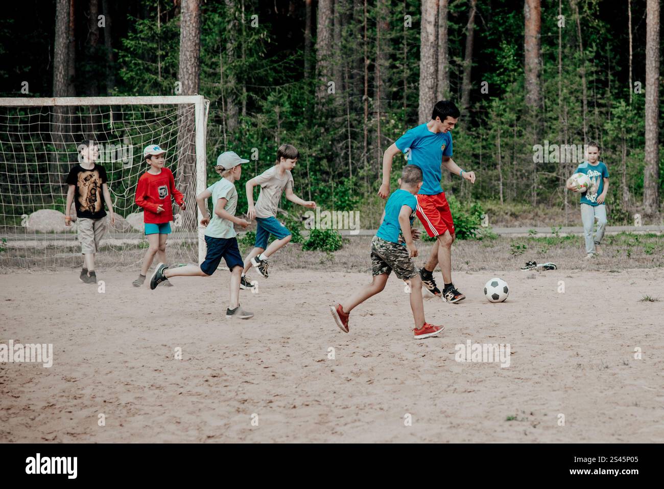 Football match on the soccer field, fans are sitting in the stands ...