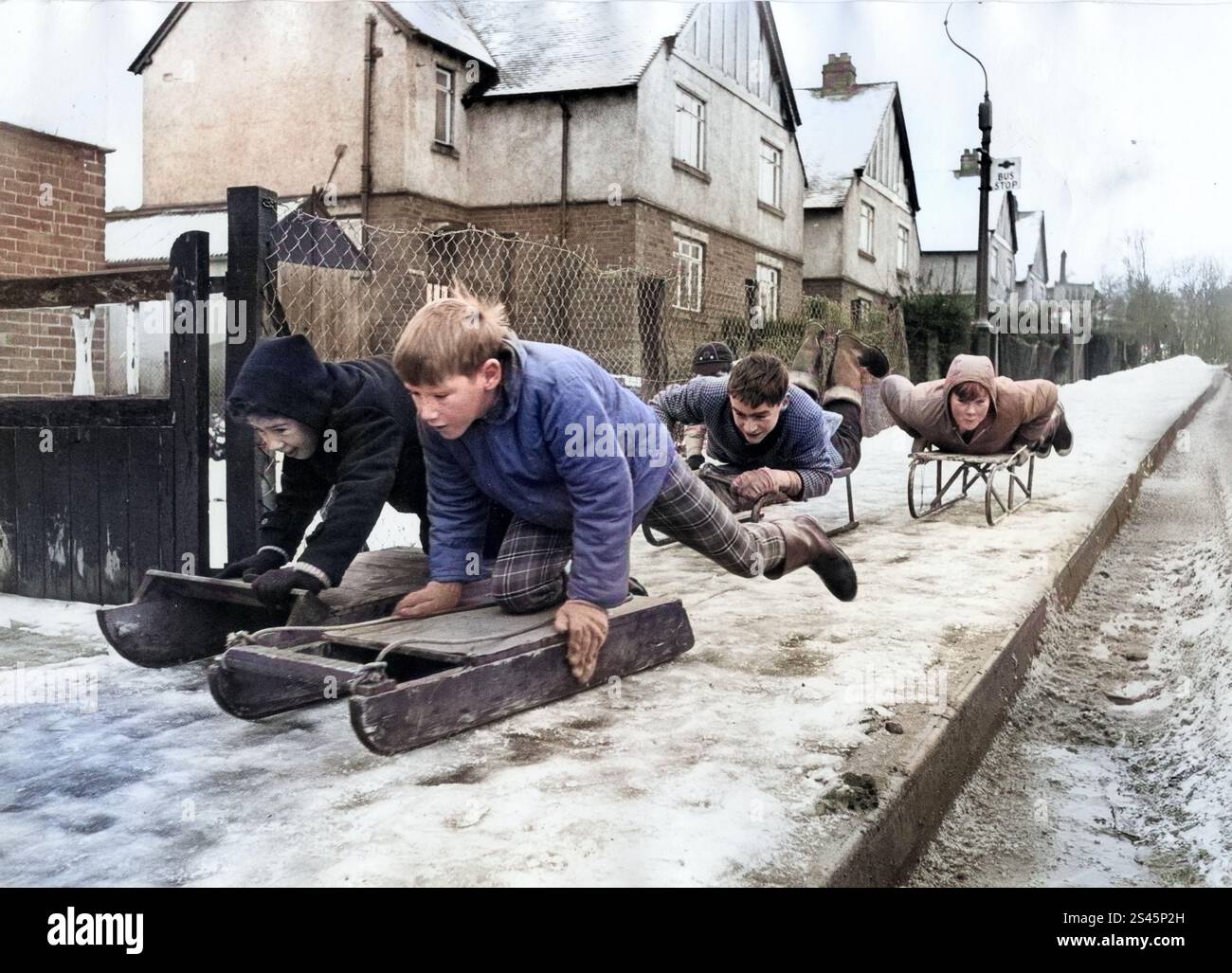 Boys children sledging on pavement Bridgnorth Shropshire Britain 1964 ...