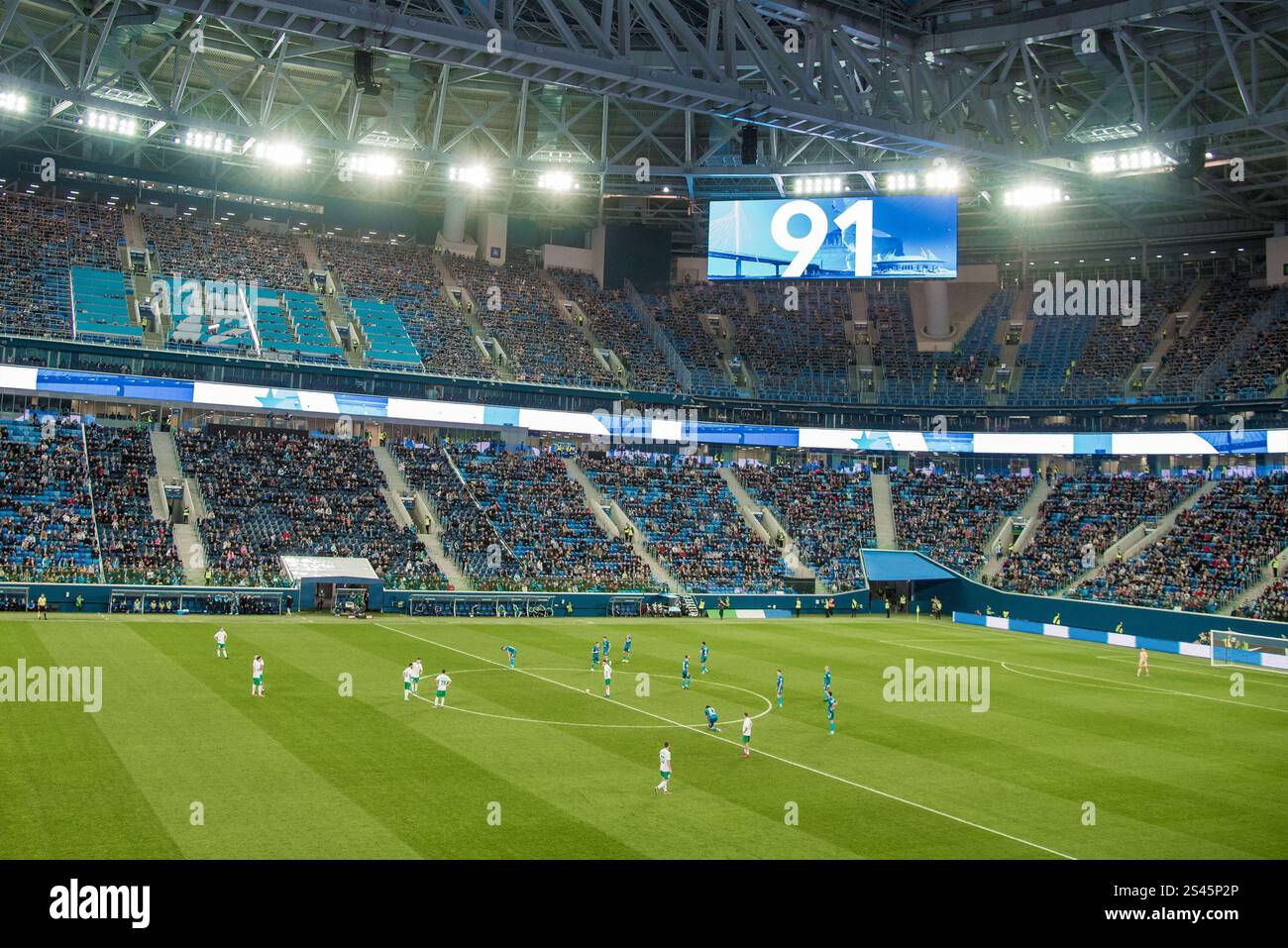 Football match on the soccer field, fans are sitting in the stands ...