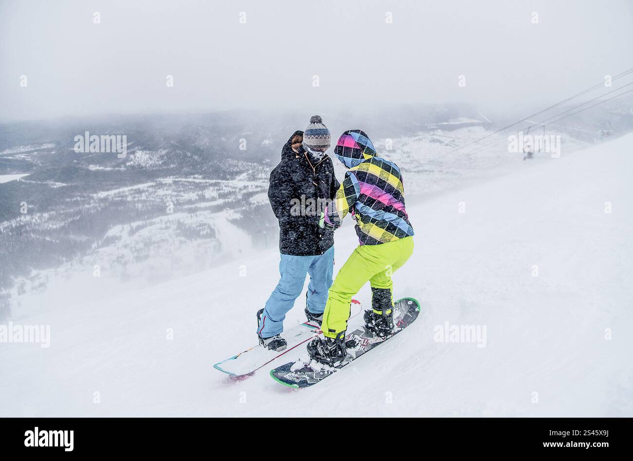 Snowboarder sliding down a snowy slope, rider relaxing at a ski resort ...