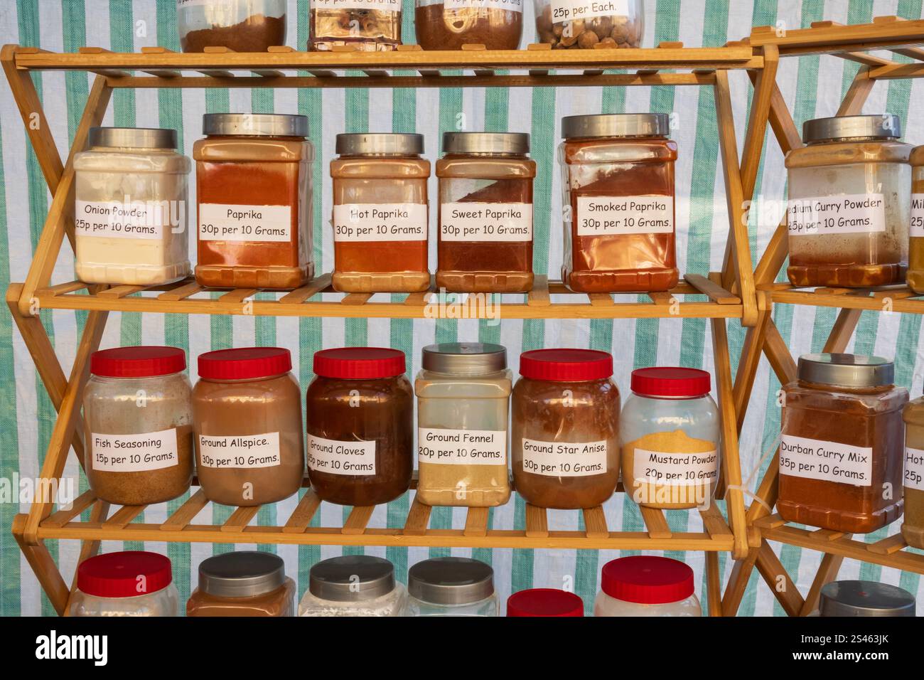 Various jars of different exotic spices for sale on a market stall ...