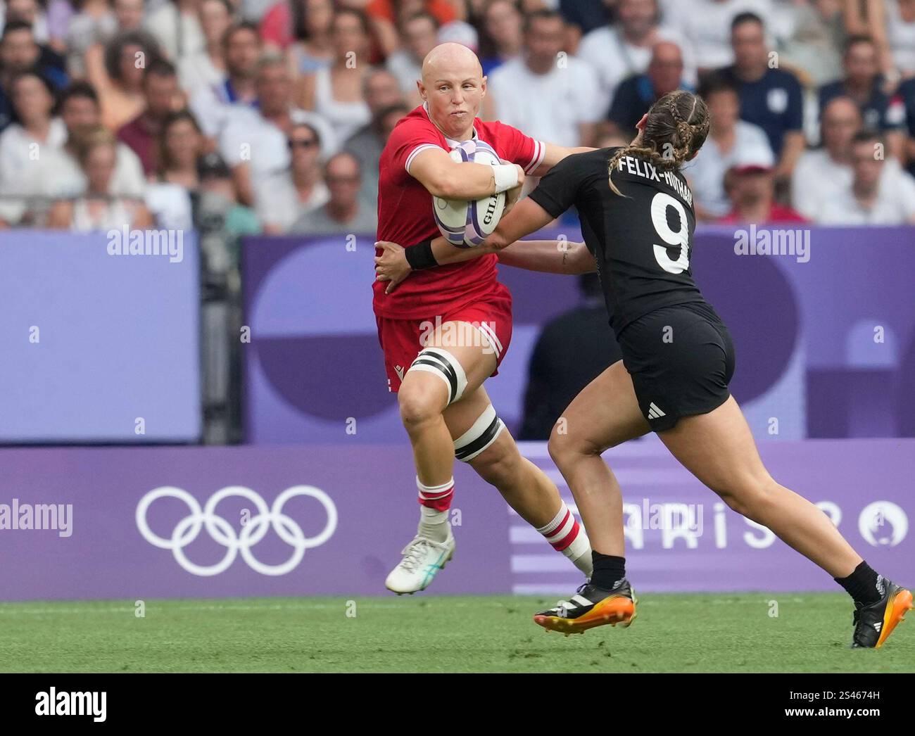 Paris, France. 30th July, 2024. Canada back Olivia Apps (2) runs by New ...