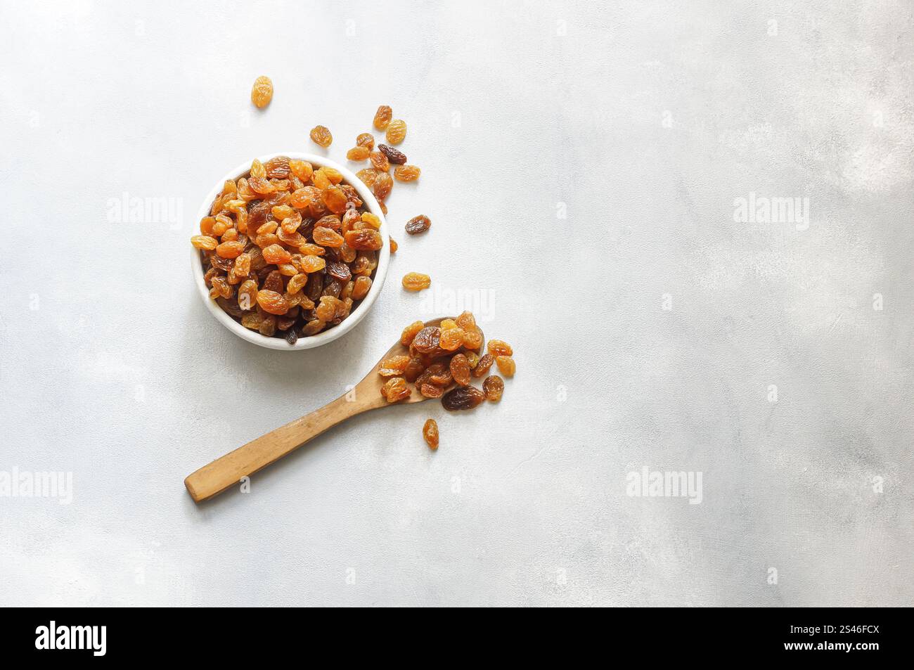 Dried grapes in wooden bowl or scoop on rustic background, healthy dry ...