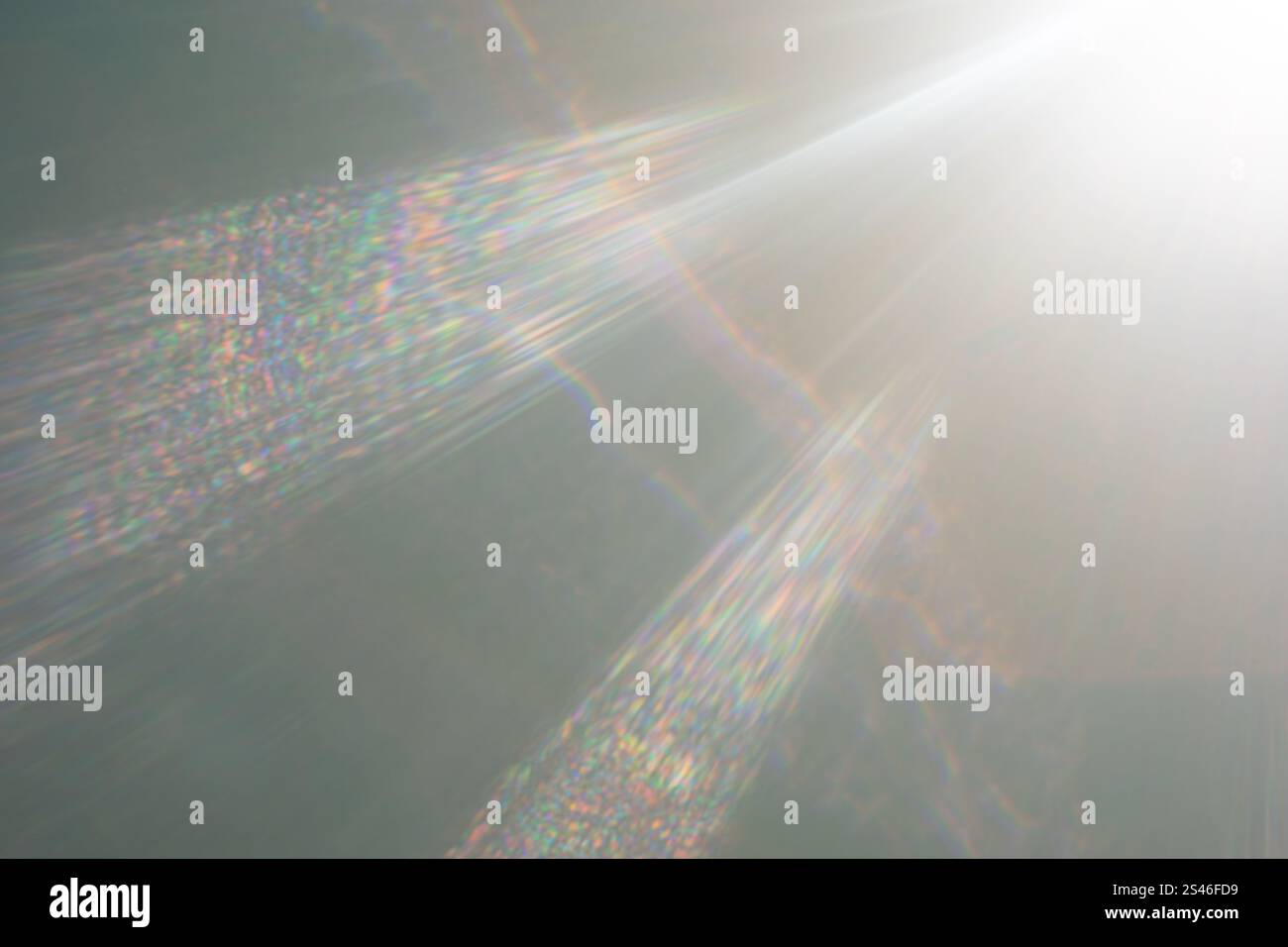Bright sunlight beams creating iridescent lens flare Stock Photo - Alamy