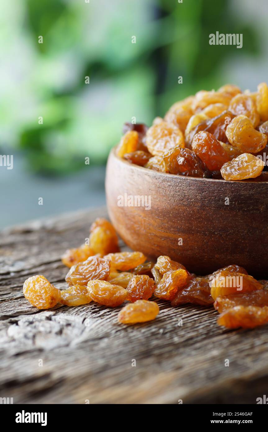 Dried grapes in wooden bowl or scoop on rustic background, healthy dry ...