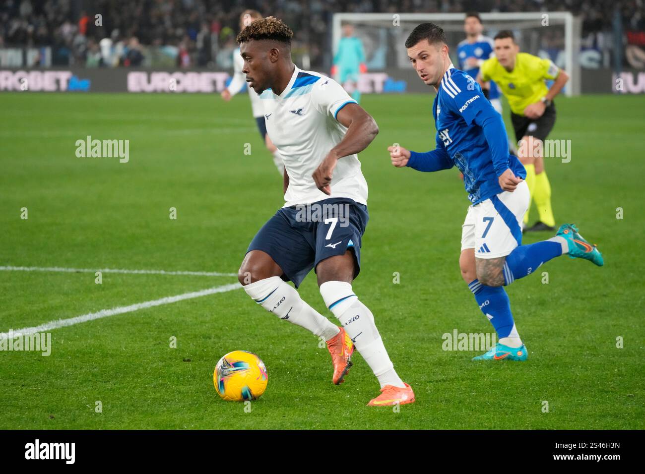 Lazio's Fisayo Dele-Bashiru, centre, and Como's Gabriel Strefezza challenge for the ball during ...