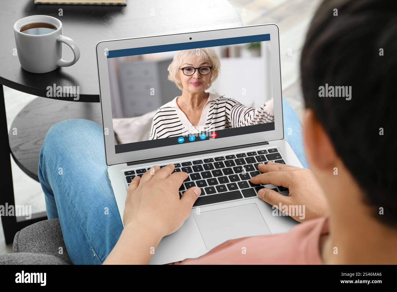 Grandmother and grandson talking via video call on laptop. Man using ...