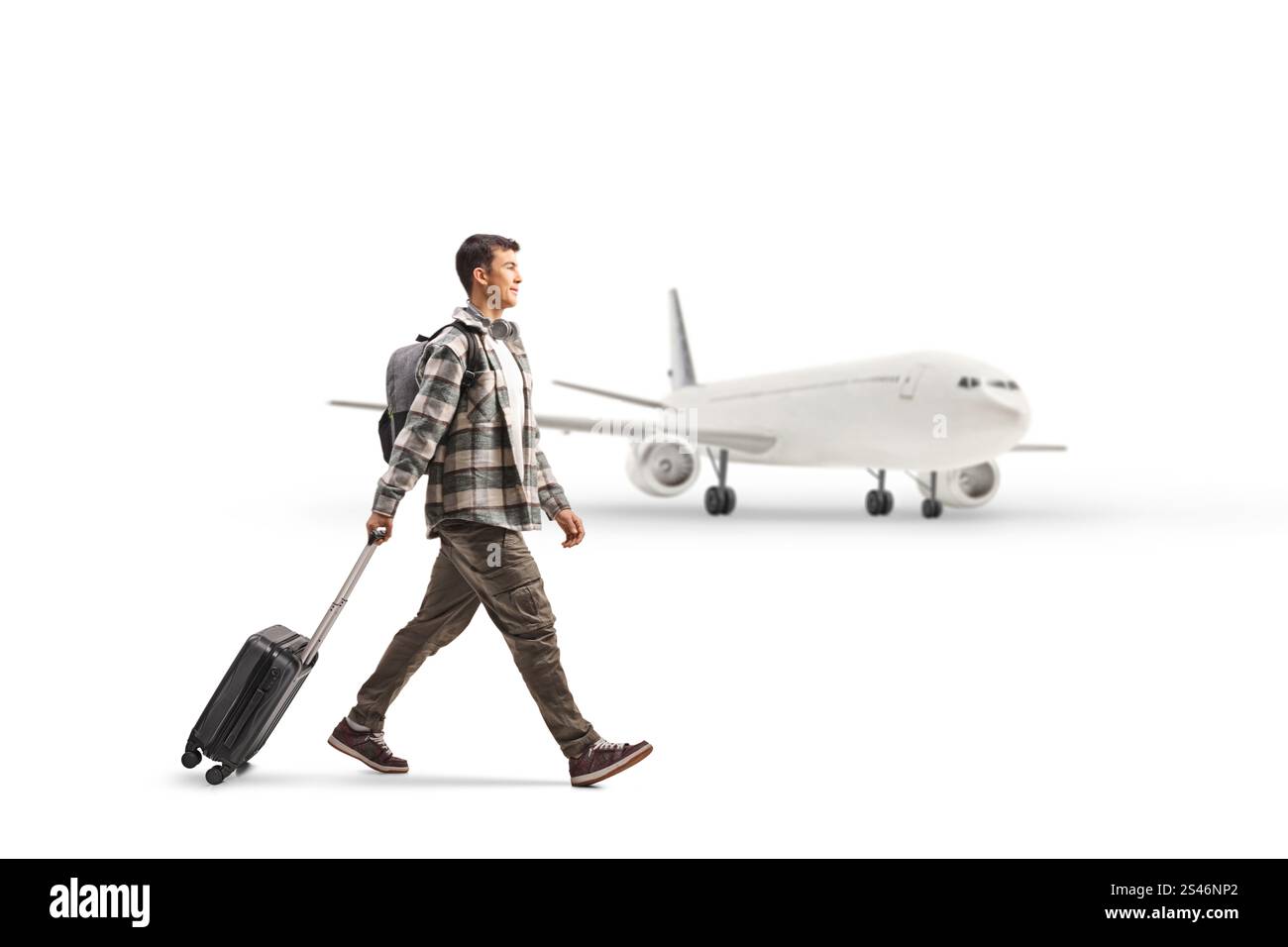 Full length profile shot of a student pulling a suitcase and walking ...