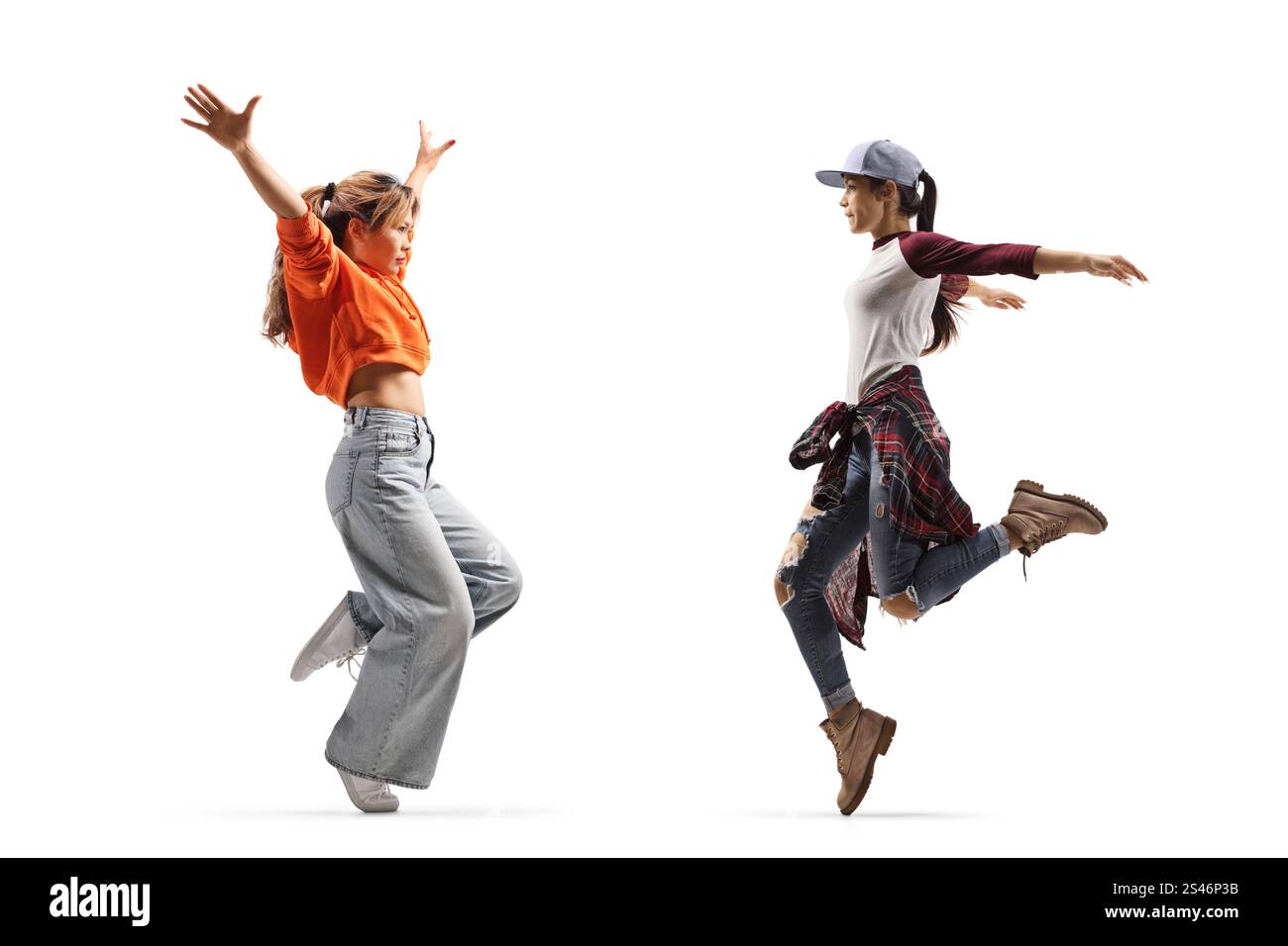 Full length profile shot of two young women dancing street dance ...