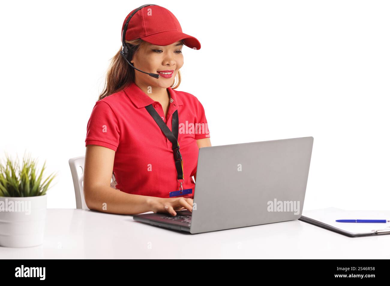 Asian female worker in a dispatch center working with a laptop computer ...