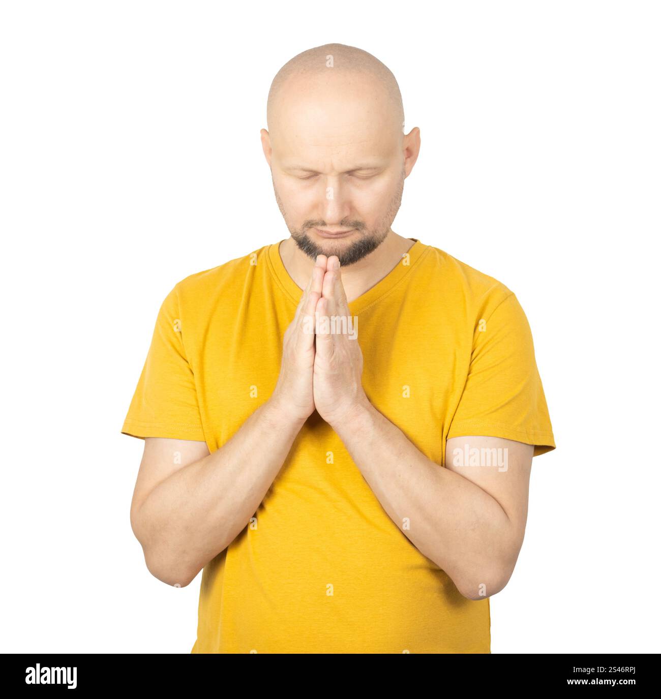 A bald man with a short beard wearing a yellow t-shirt poses against a ...