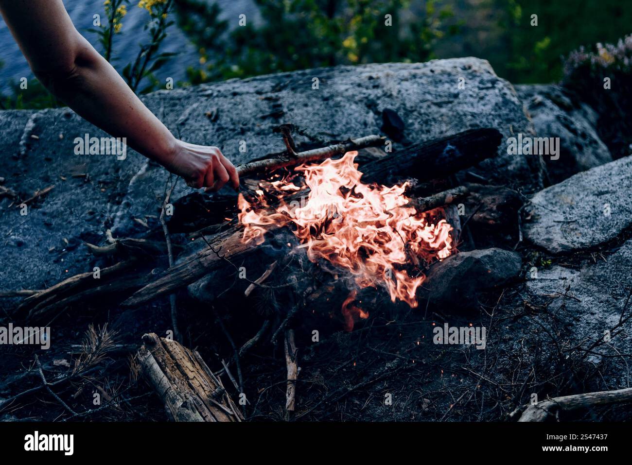 Campfire at the tourist campsite, hiking tourism on weekend vacation ...