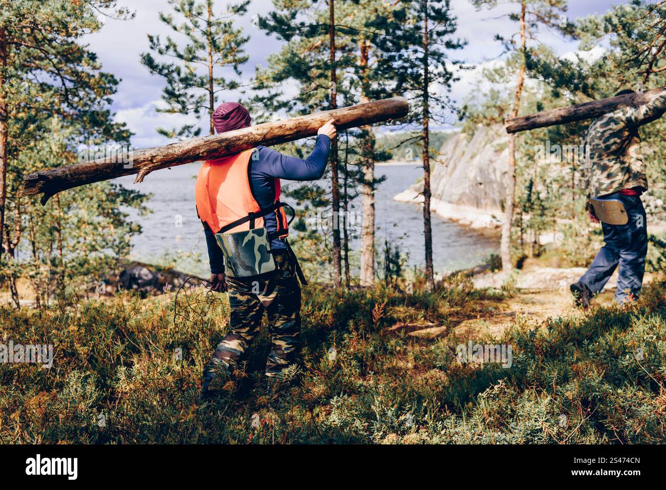Tourists carrying firewood to tourist tent camping, man holding a log ...